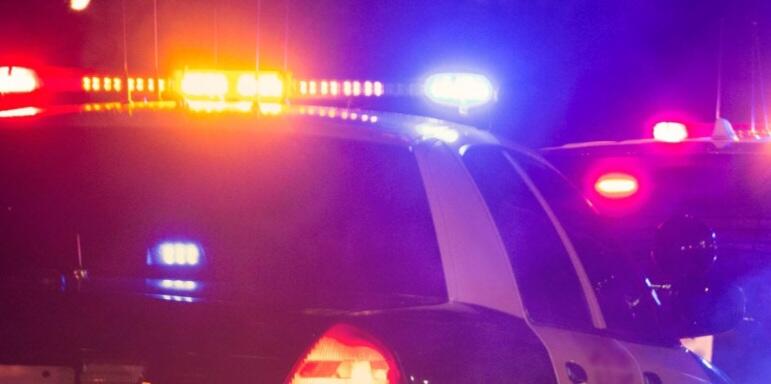 Police officer dropping off patrol car for service arrests employee ...