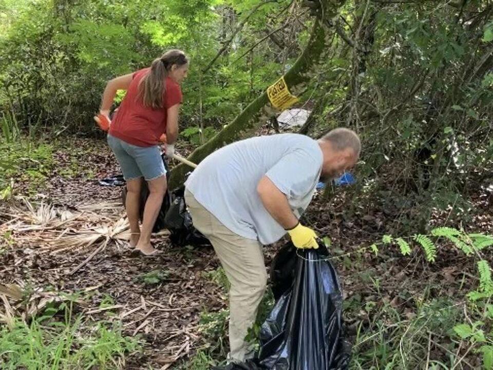 Volunteers clean up abandoned homeless encampment