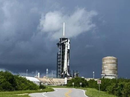 A SpaceX Falcon 9 rocket with the Crew Dragon Resilience capsule sits ...