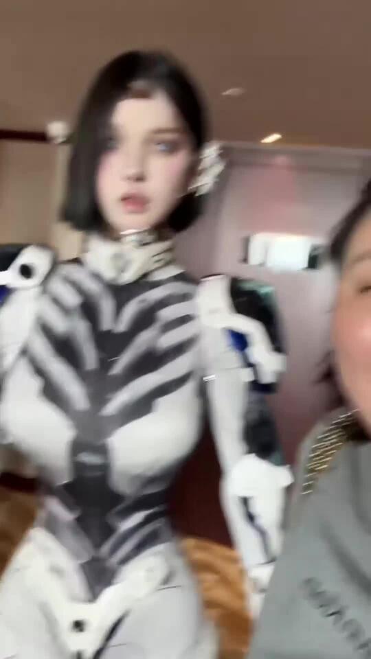 Taking a selfie video with an AI robot girl as we stroll together, capturing her lifelike ...