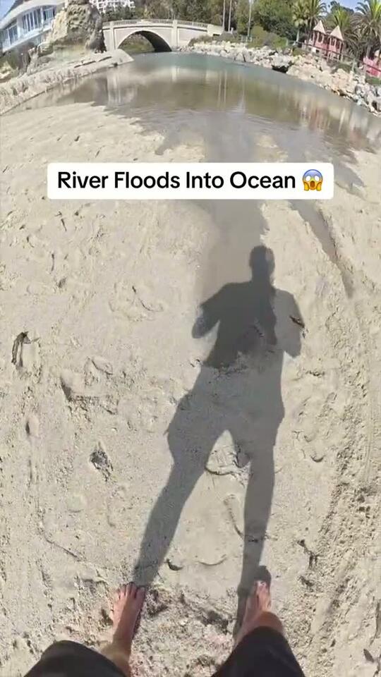 Heavy_rain_causes_a_lake_to_overflow__creating_a_stream_of_water_that ...