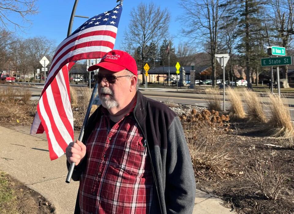 Man waving American flag faces two demonstrations at Lincoln Park ...