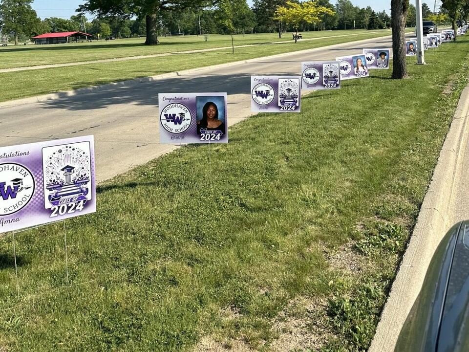 Personalized signs honoring Woodhaven graduates line Hall Road