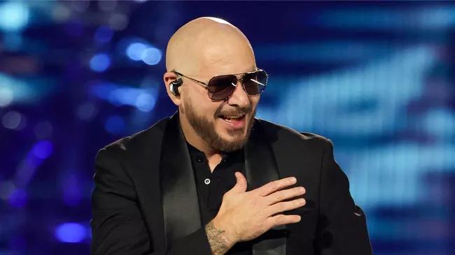 Why Some Pitbull Fans Wear Bald Caps & Sunglasses To His Concerts ...