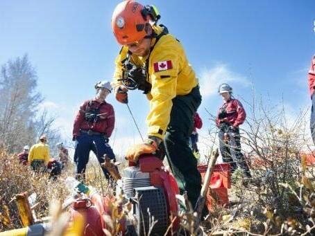A Canadian firefighter in training in Quebec province practices using a ...