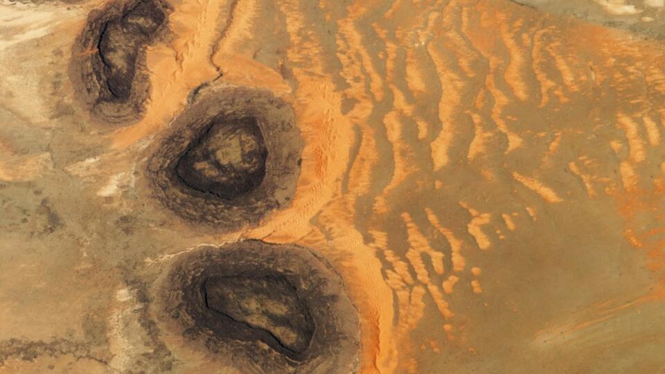 Trio of 'black mesas' leftover from Paleozoic era spawn rare sand dunes ...