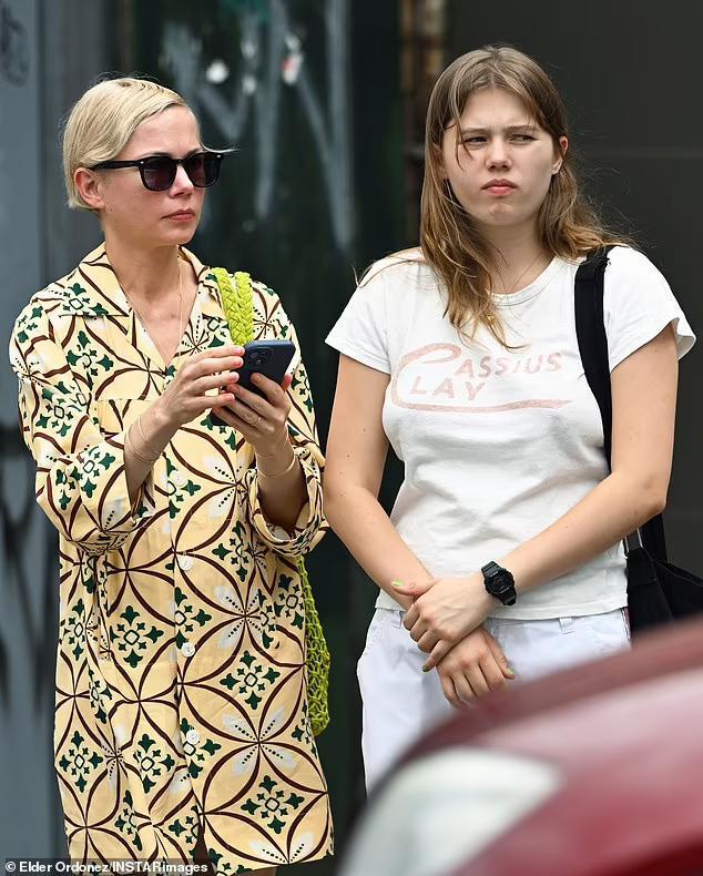Michelle Williams, 43, walks hand-in-hand with daughter Matilda, 18, who is the spitting image ...