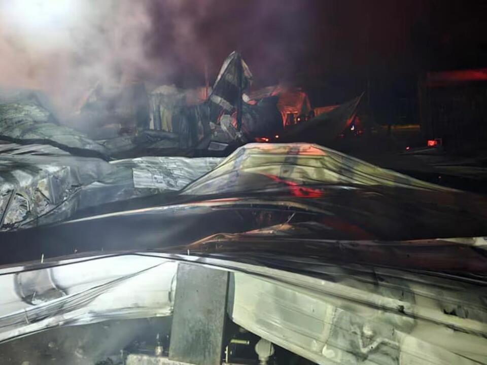 Crews respond to shop building fire, vehicles inside