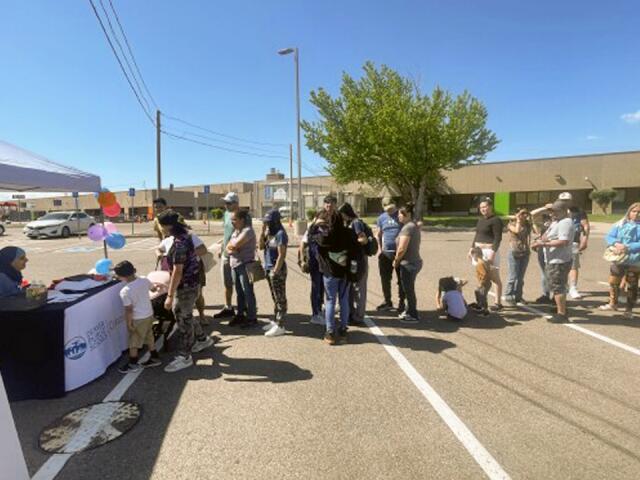 Educators distribute donations to hundreds of immigrant students ...