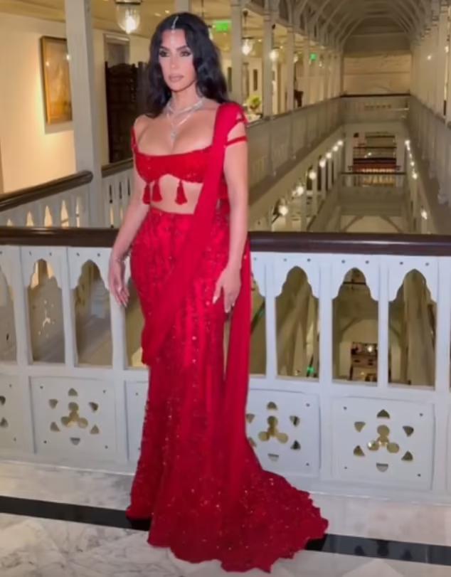 Kim Kardashian stuns in a sparkling ruby red ensemble while sister ...