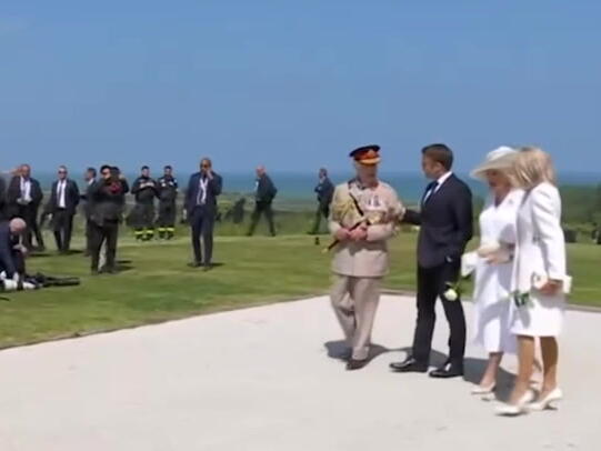 Brigitte Macron tries to hold Queen’s hand at D-Day memorial