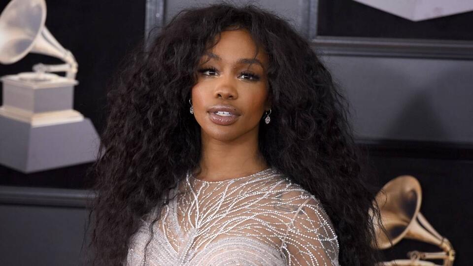 SZA Poses on a Piano in a Sheer Dress - NewsBreak