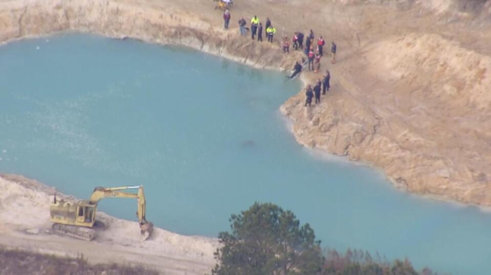 UPDATE: Operator trapped under water after excavator falls into ...