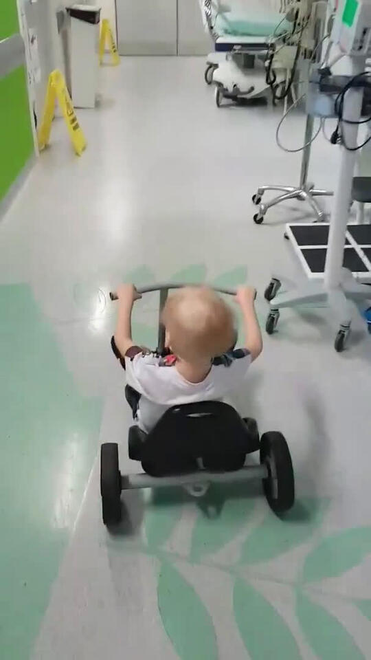 Childhood cancer patient rides tricycle around hospital to build ...