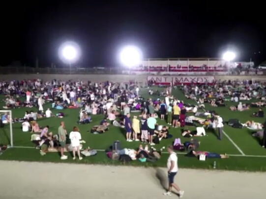 Tourists shelter in stadium after wildfire causes evacuations on Greek ...