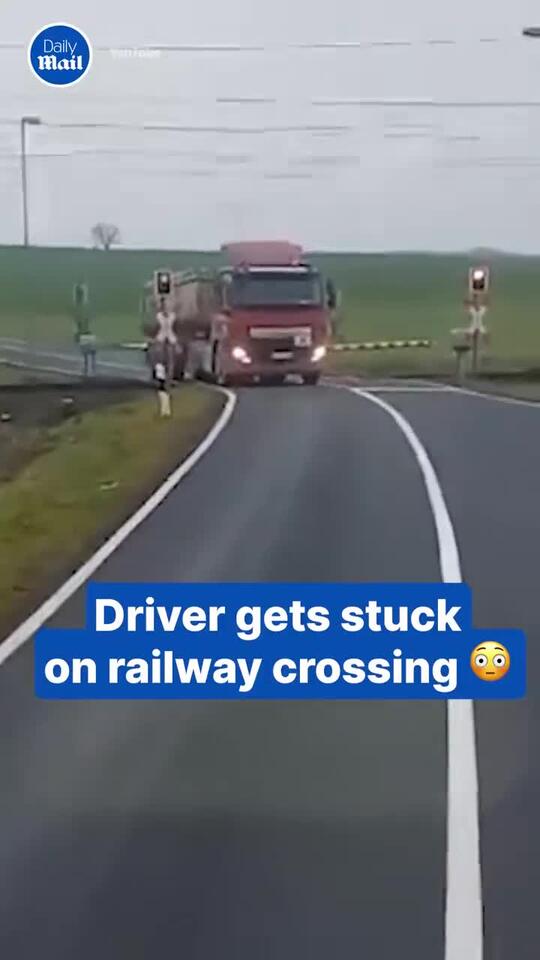 This is the heartpounding moment a truck driver stuck on a level ...