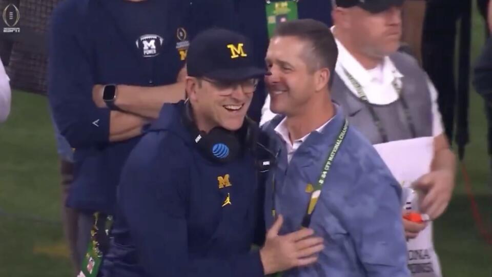 Jim Harbaugh shares nice moment with brother John during title game ...