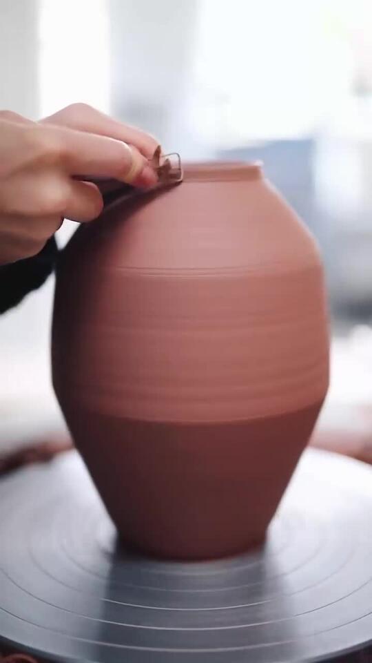 Trimming a large angular vase on the potters wheel Thrown from a high ...