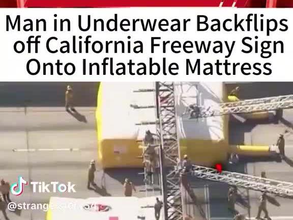 man do a backflip off California freeway sign