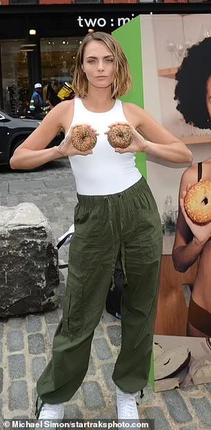 Cara Delevingne puts on a cheeky display with two bagels as she poses ...