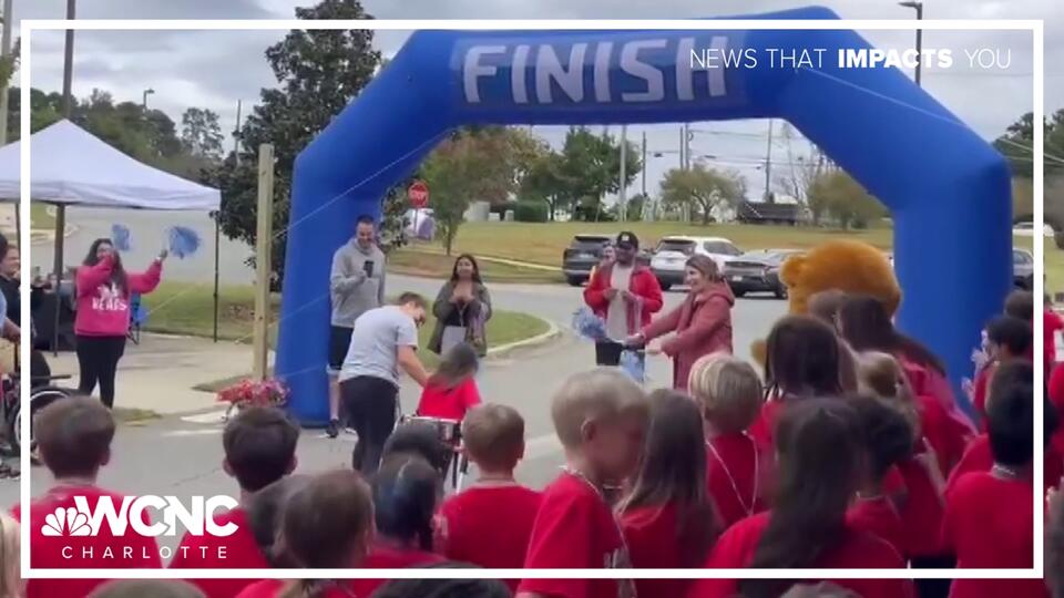3rd graders cheer on classmate as she crosses fun run finish line using ...