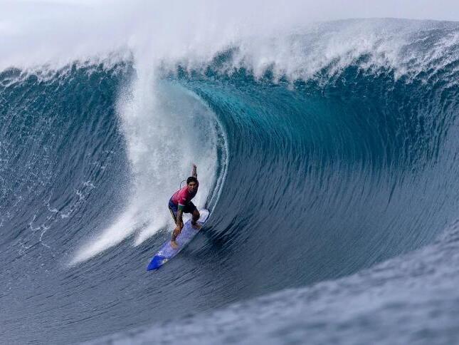 Brazilian surfer's historic ride at the Olympics spawns iconic photo