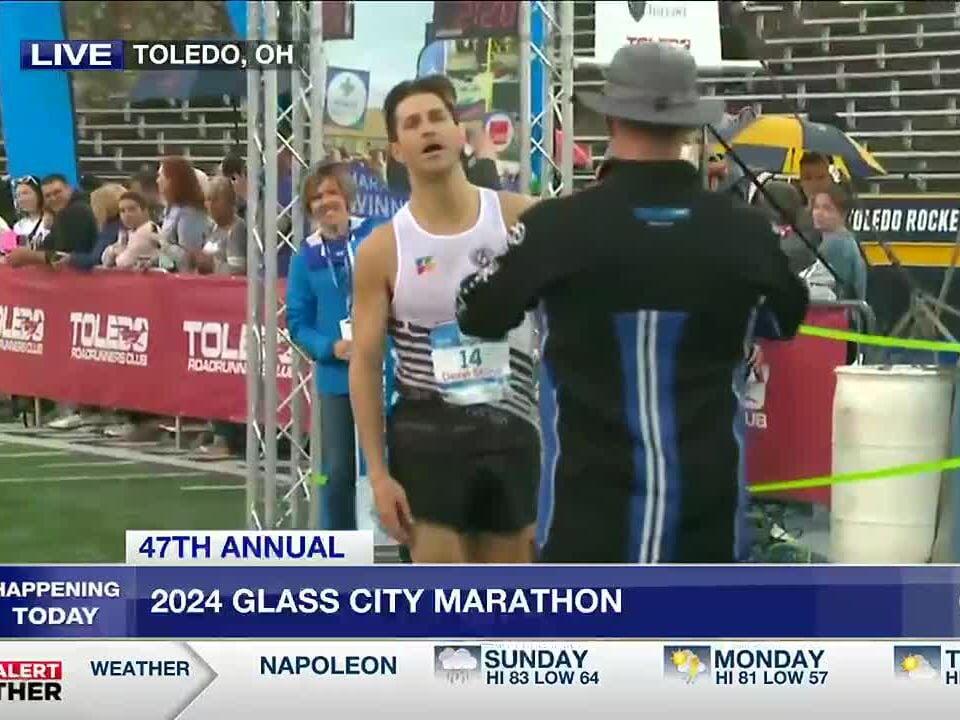 1st place runner crosses finish line at 2024 Glass City Marathon