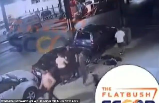 Mystery as large group of men emerge from manhole into middle of busy ...