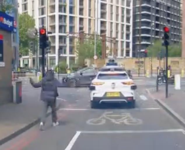 Moment man hurls 'rock' at Waymo multiple times - before 'driverless ...