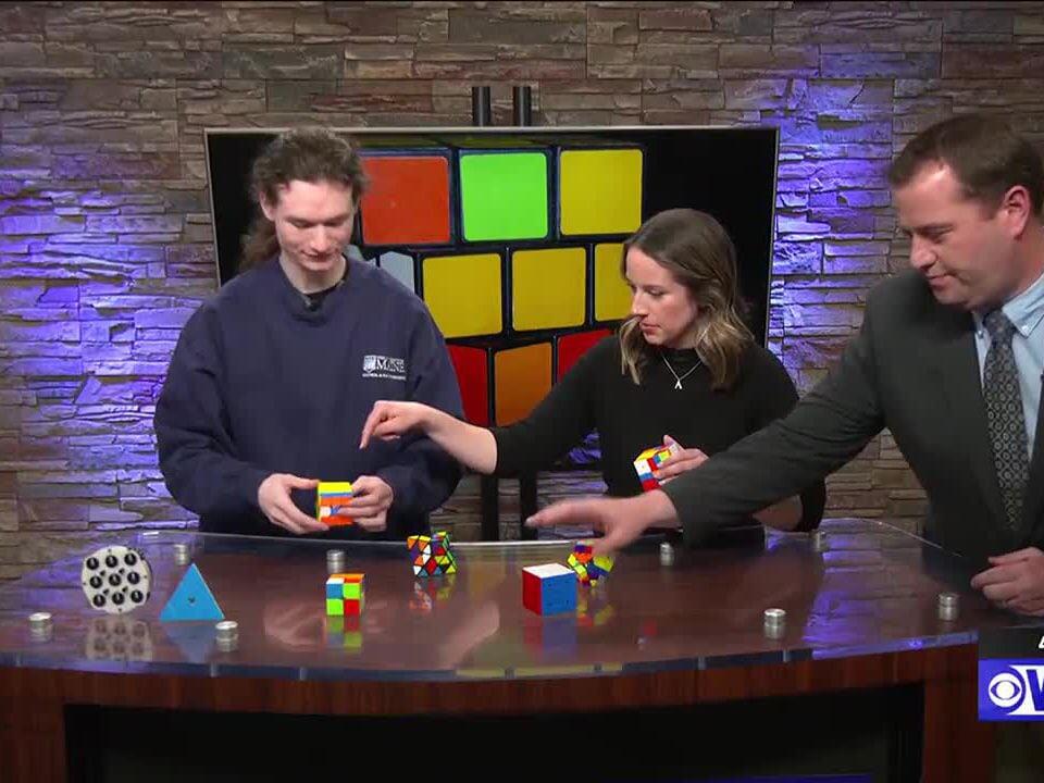 UMaine student competing in Rubix's Cube Competition shows off his skill
