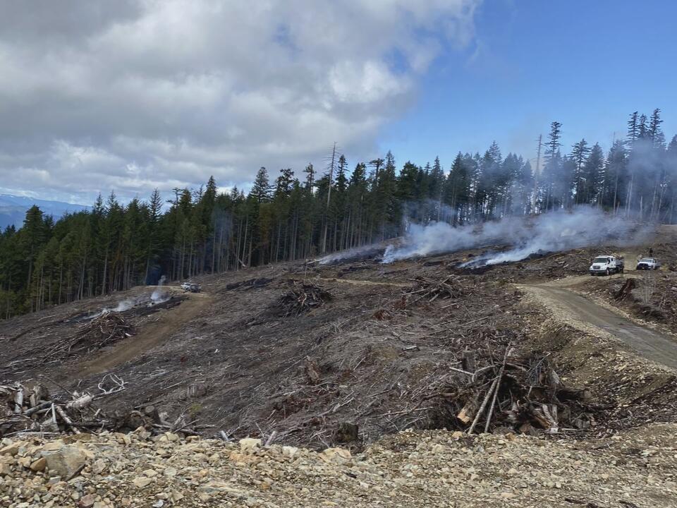 Agencies respond to large burning slash piles in Josephine County