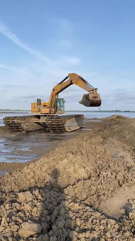 A @weeksmarine marsh buggy building a berm to control the flow of ...