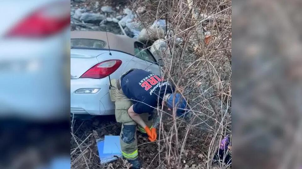First responders rescue three after car crashes off of parking lot ...