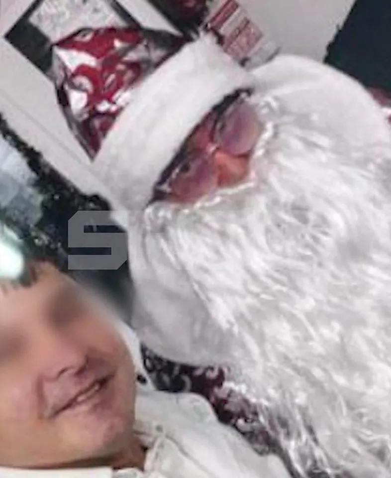Moment assassin disguised as Santa poses for selfie with unsuspecting ...